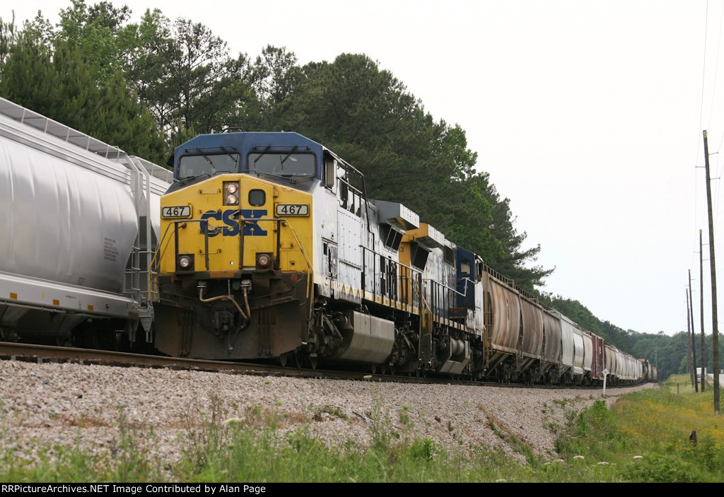 CSX CW44AC 467 and CW40-9 9013 wait for green as southbound mixed freight passes